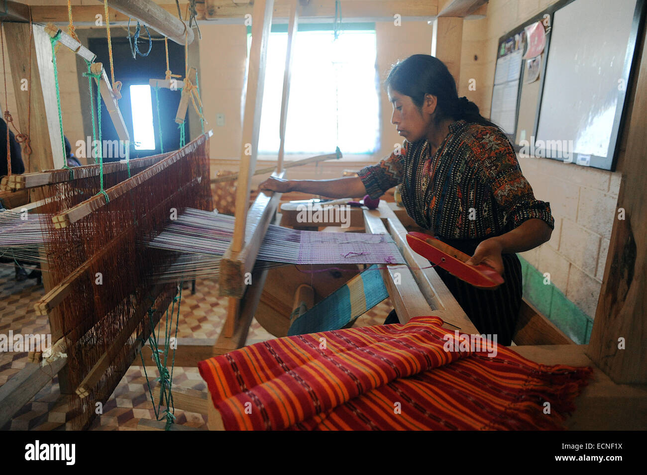 A maya indigenous woman weaves on loom in Churacruz, Solola, Guatemala ...
