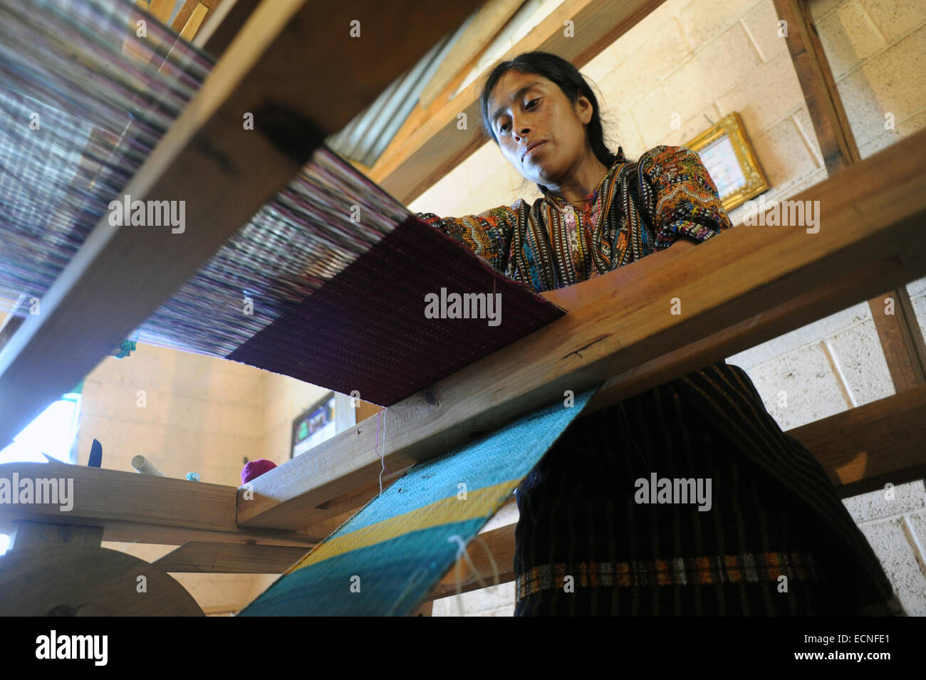 A maya indigenous woman weaves on loom in Churacruz, Solola, Guatemala ...