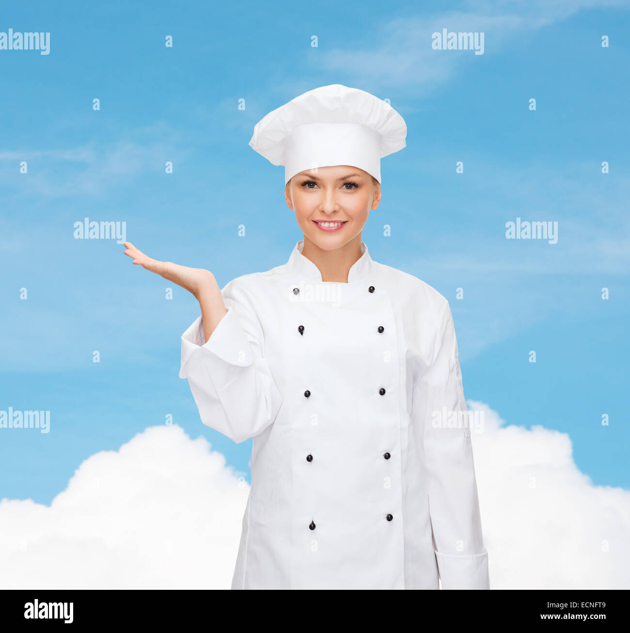 smiling female chef holding something on hand Stock Photo - Alamy