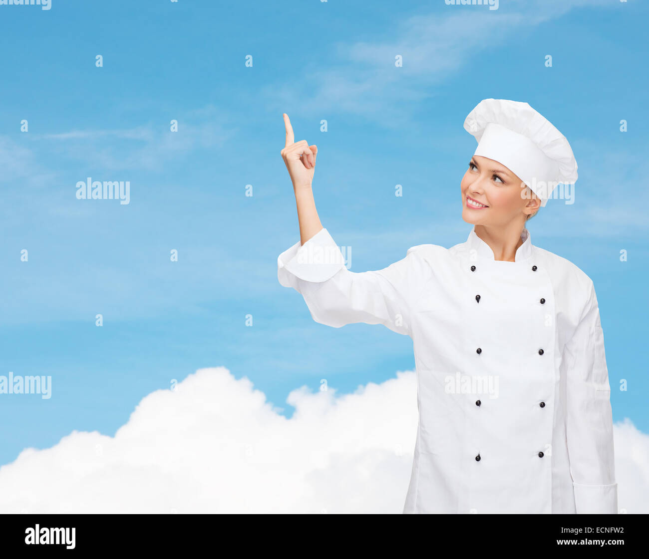 smiling female chef pointing finger to something Stock Photo - Alamy