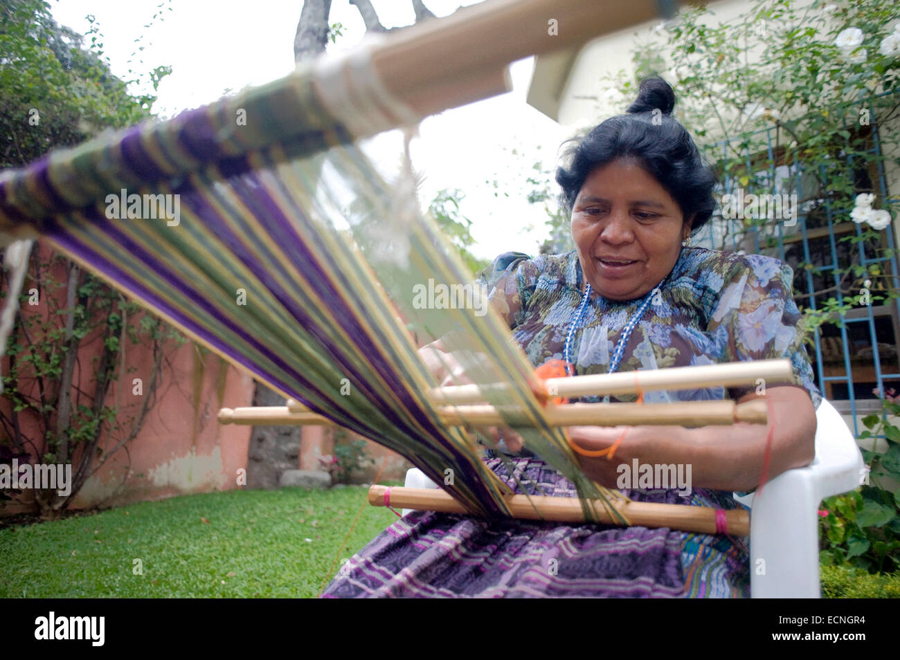 A maya indigenous woman weaves on backstrap loom in Panajachel, Solola ...