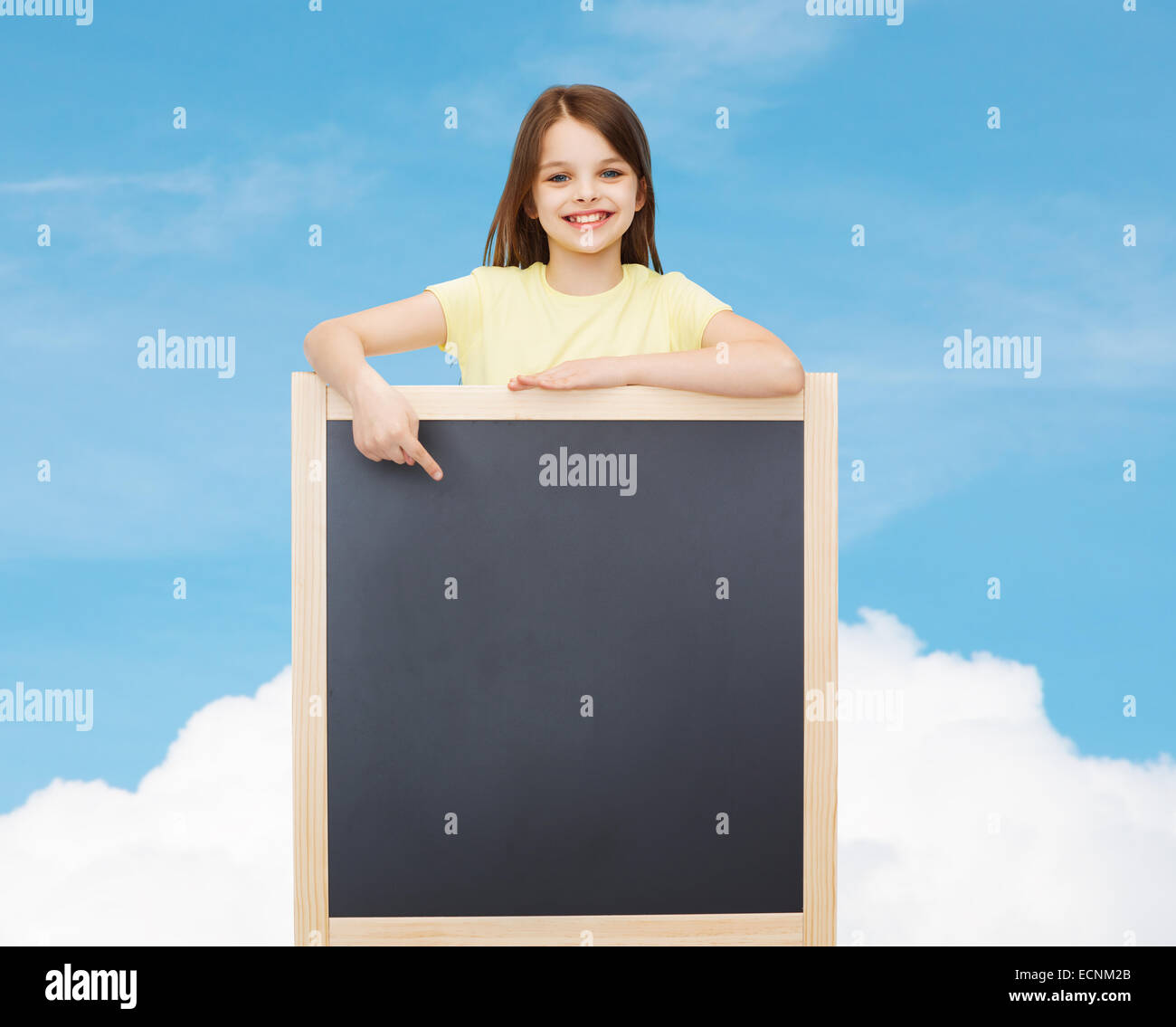 happy little girl pointing finger to blackboard Stock Photo - Alamy