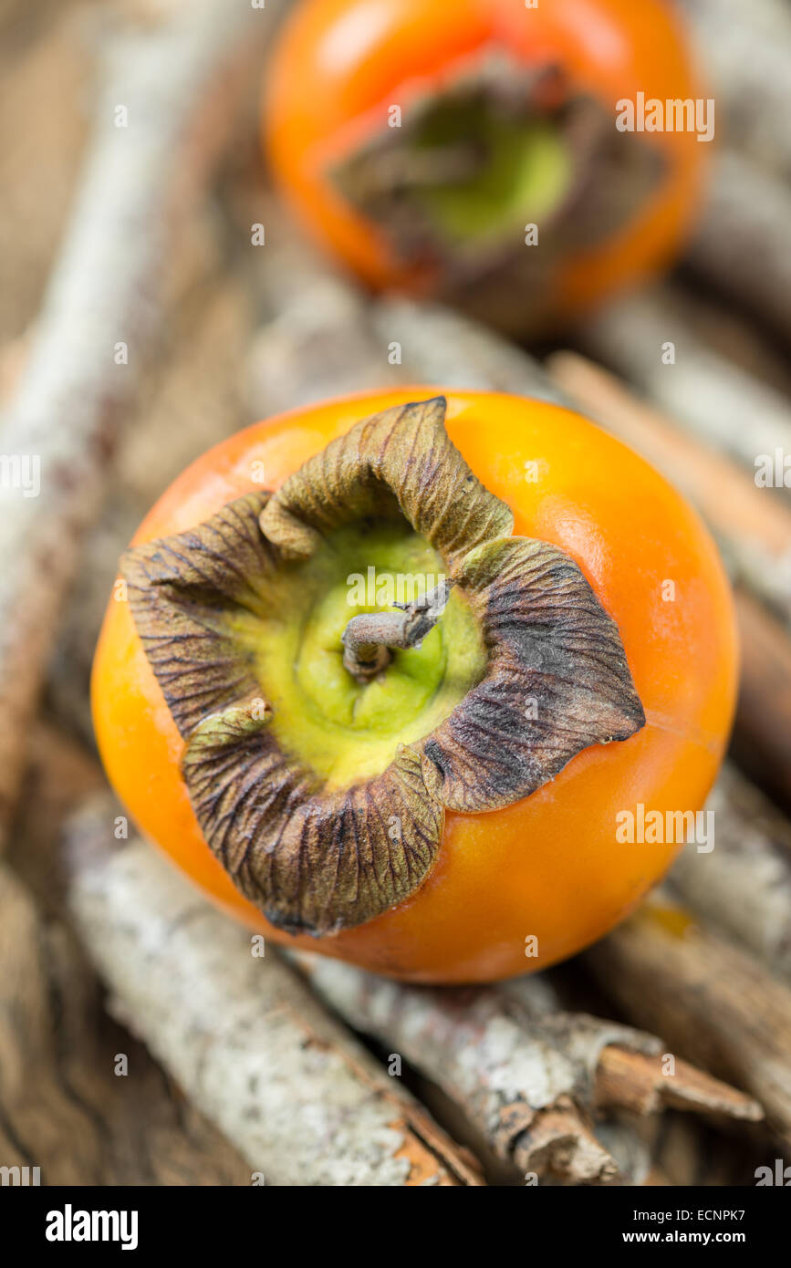 fresh natural kaki fruits on wooden table Stock Photo - Alamy