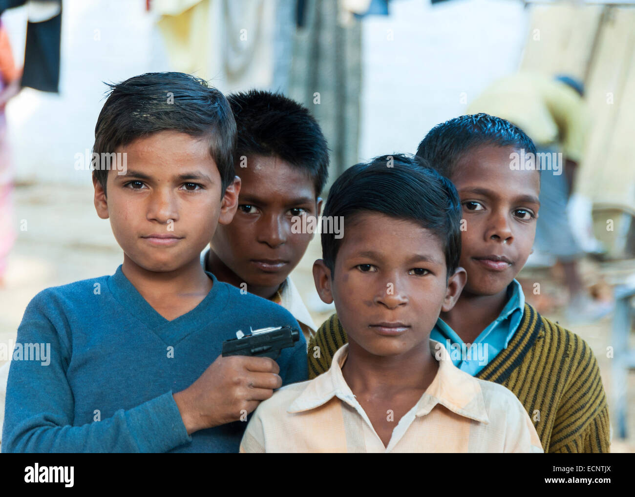 Four boys, one holding toy gun Stock Photo - Alamy