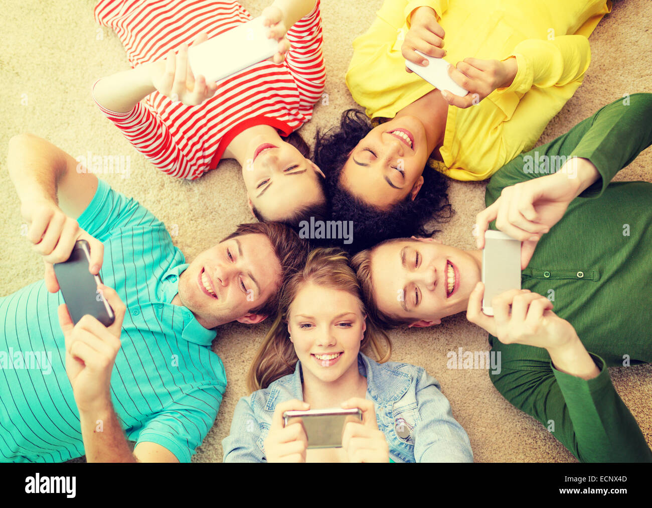 group of smiling people lying down on floor Stock Photo - Alamy
