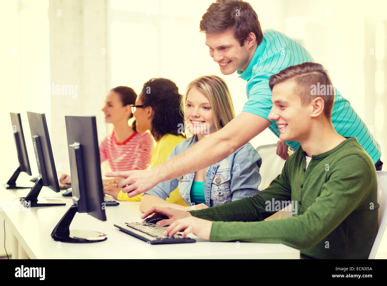 smiling students in computer class at school Stock Photo - Alamy