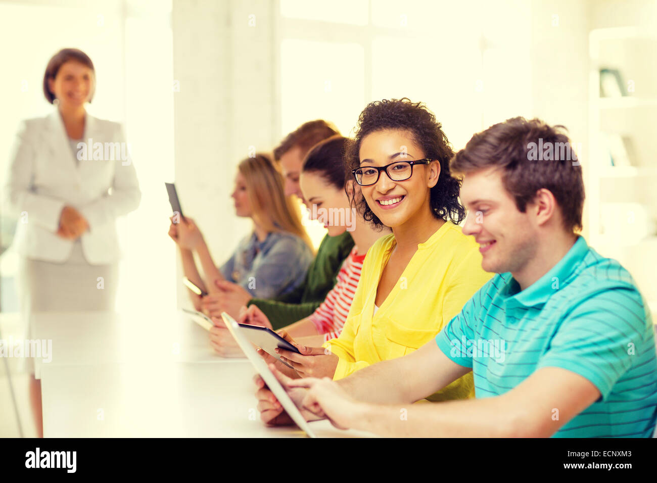 smiling female students with tablet pc at school Stock Photo - Alamy