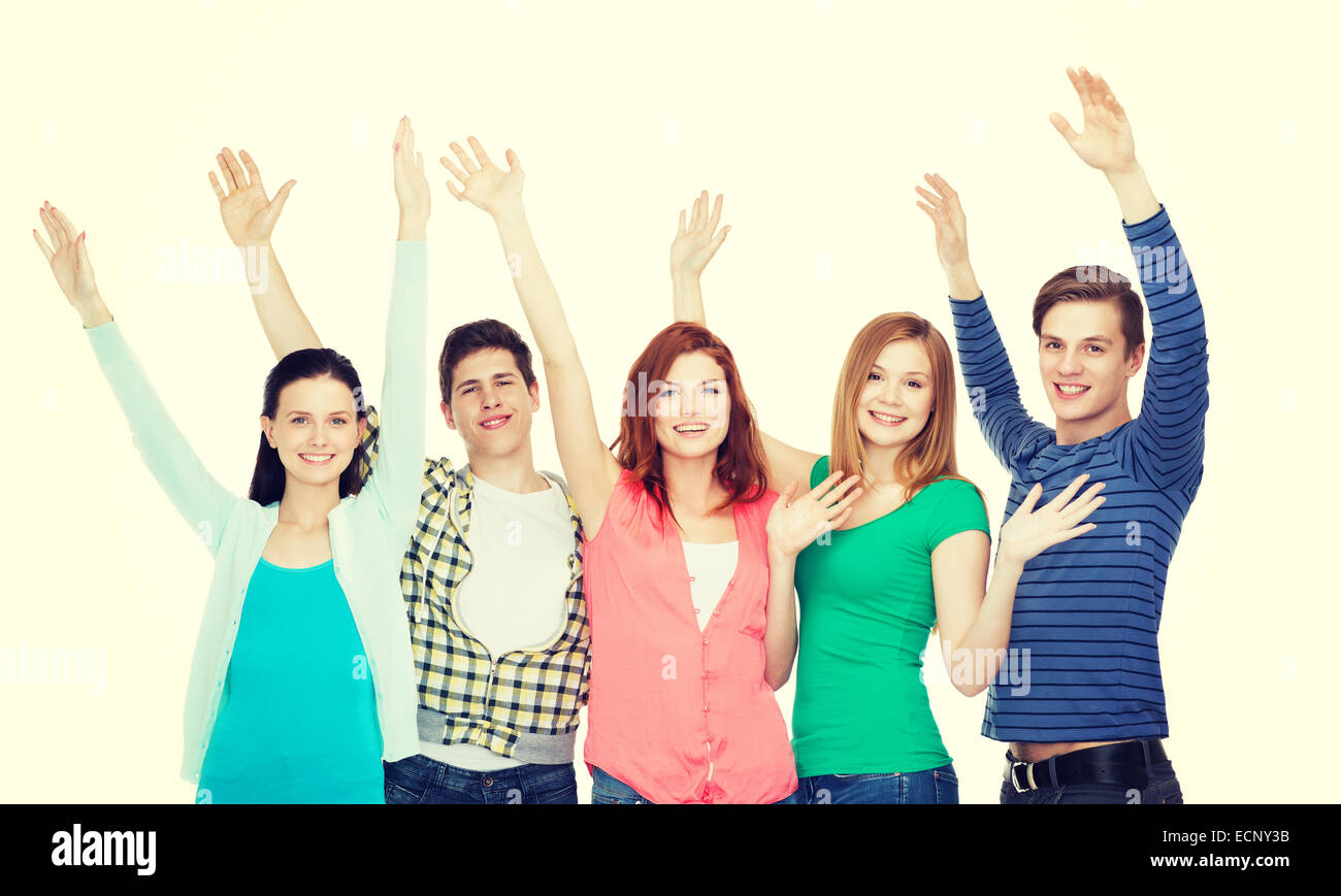 group of smiling students waving hands Stock Photo - Alamy