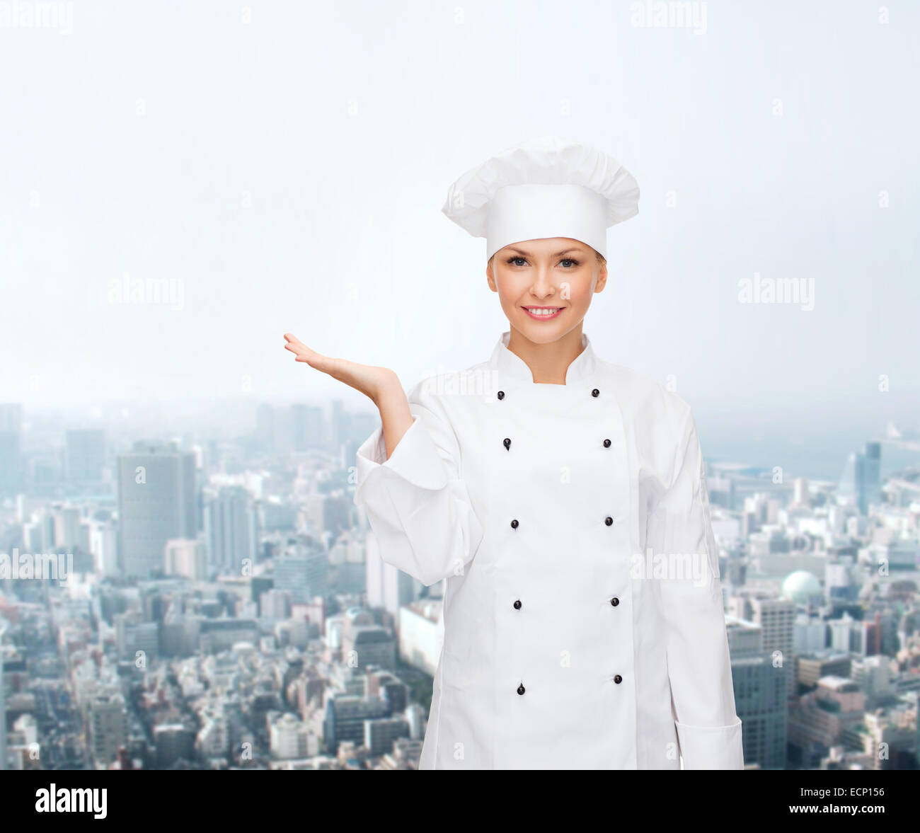 smiling female chef holding something on hand Stock Photo - Alamy