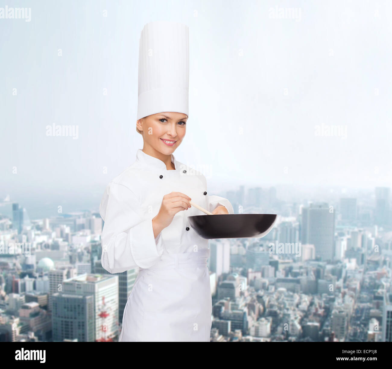 smiling female chef with pan and spoon Stock Photo - Alamy