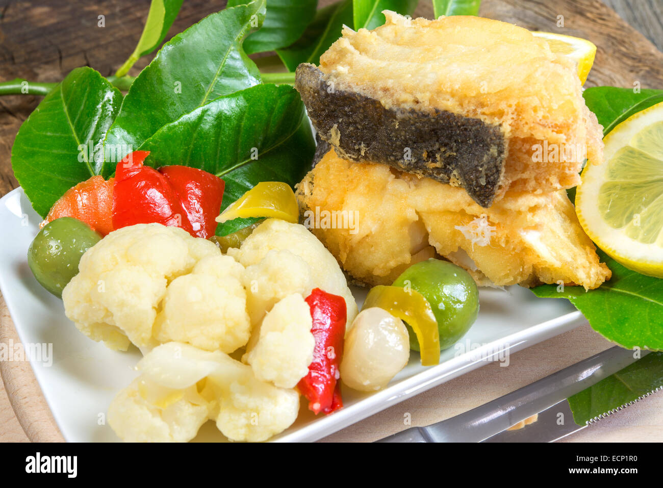 Piece of cod fried on cabbage salad Stock Photo - Alamy