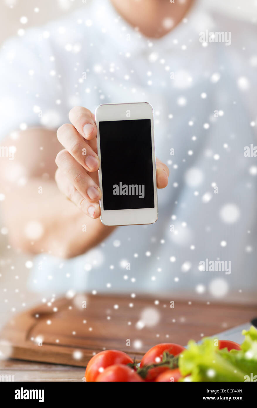 closeup of man showing smartphone in kitchen Stock Photo - Alamy