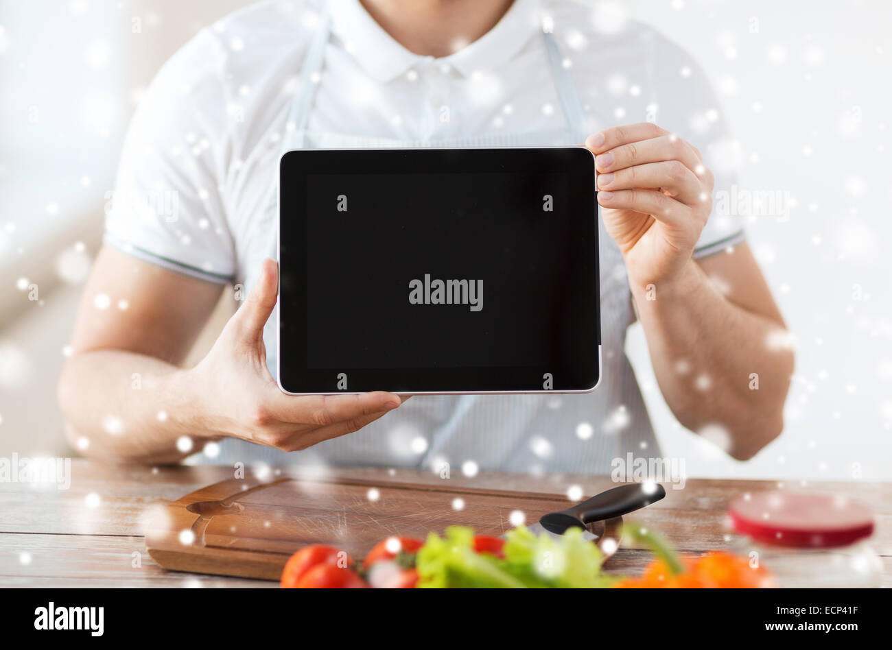 closeup of man showing tablet pc screen in kitchen Stock Photo - Alamy