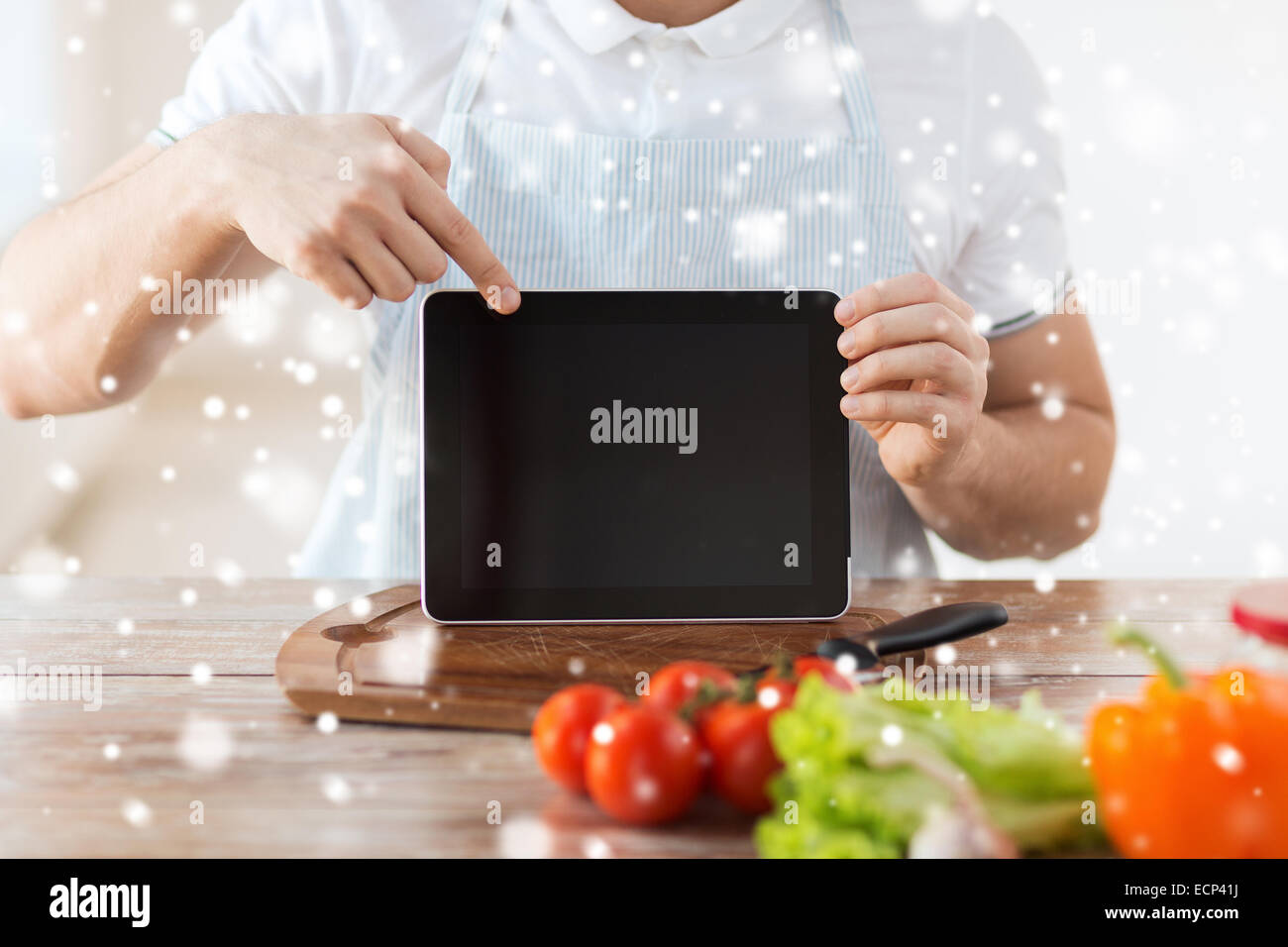 closeup of man showing tablet pc screen in kitchen Stock Photo - Alamy