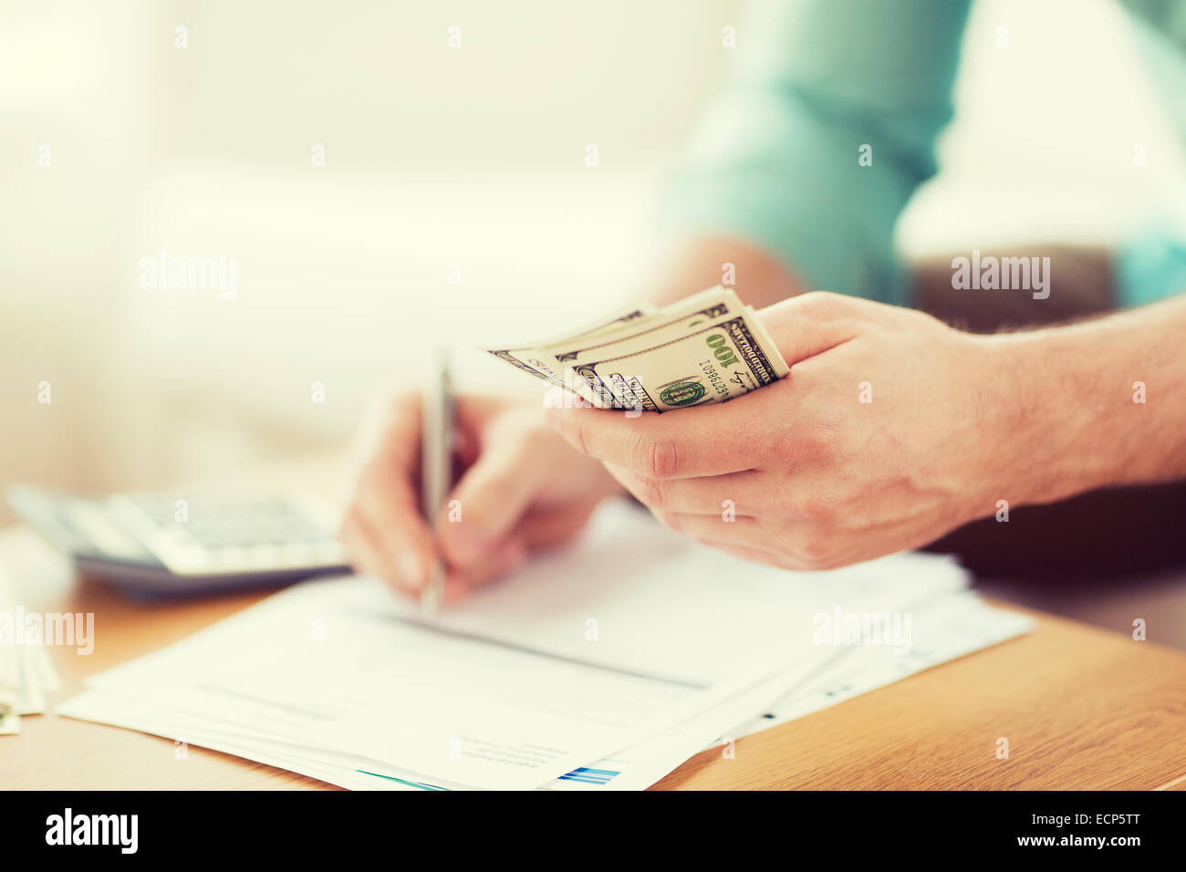 close up of man counting money and making notes Stock Photo - Alamy
