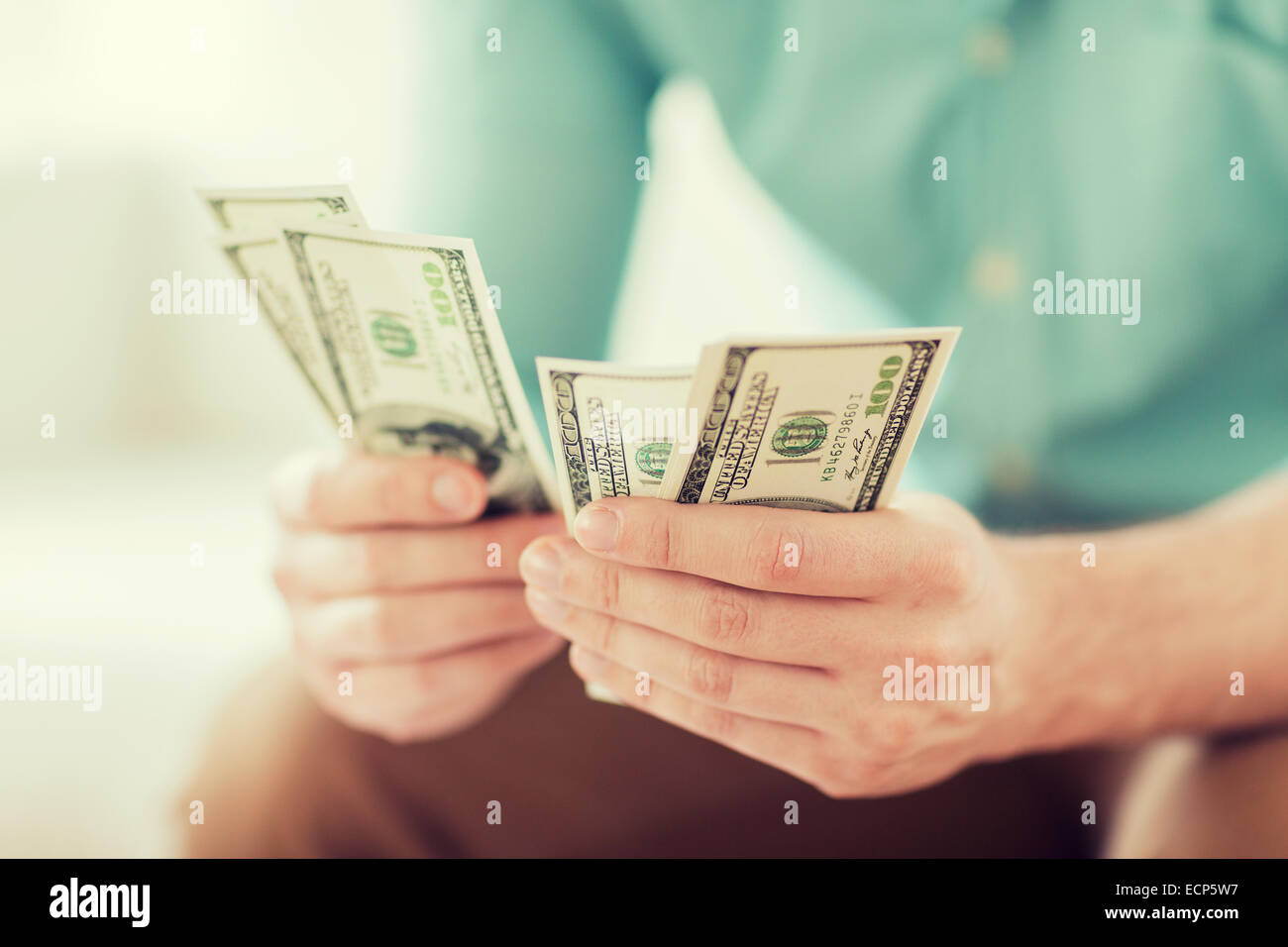 close up of man counting money at home Stock Photo - Alamy