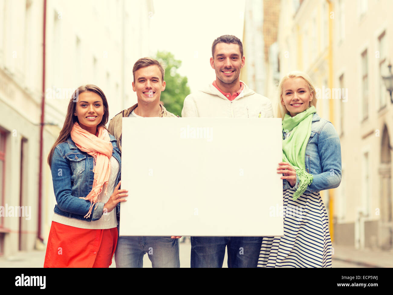 group of smiling friends with blank white board Stock Photo - Alamy