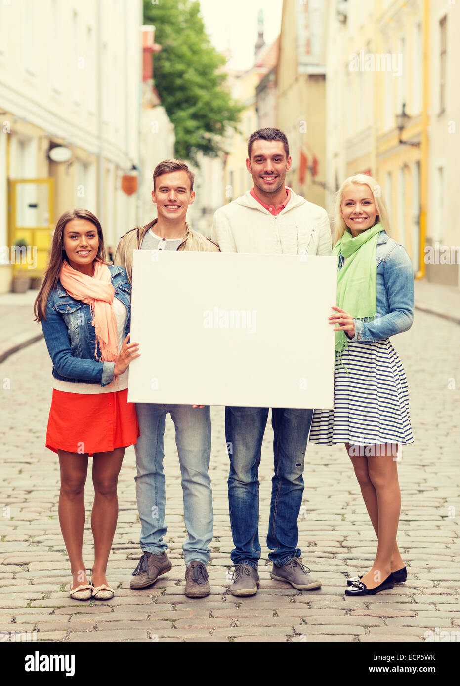 group of smiling friends with blank white board Stock Photo - Alamy