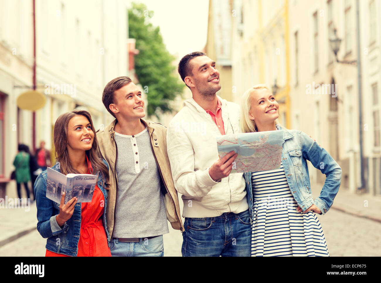 group of smiling friends with city guide and map Stock Photo - Alamy
