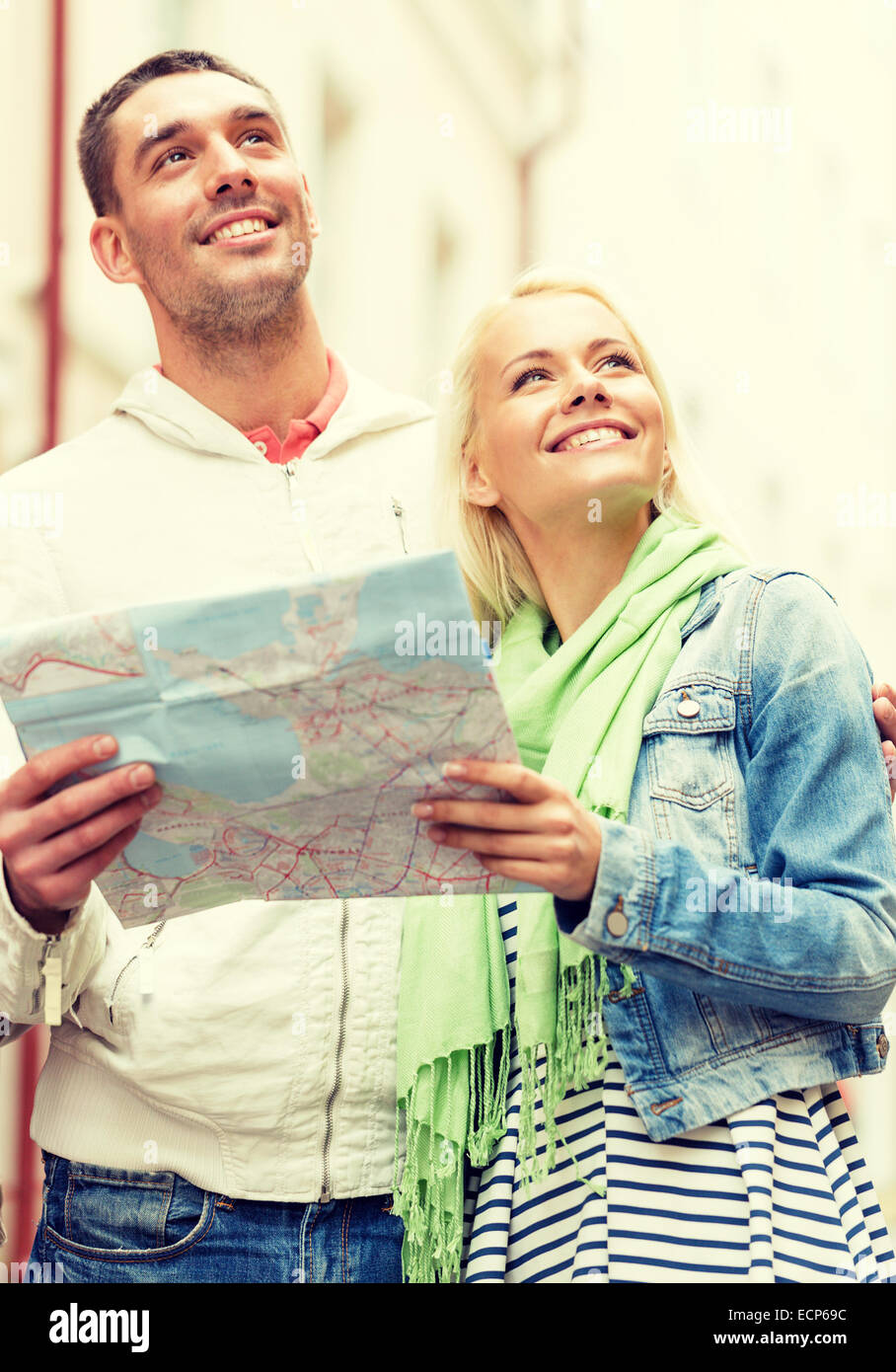 happy couple with map exploring city Stock Photo - Alamy