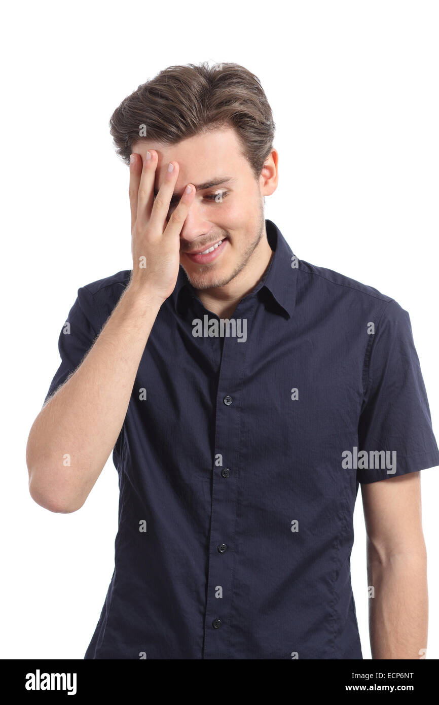 Ashamed man smiling covering his face with a hand isolated on a white ...