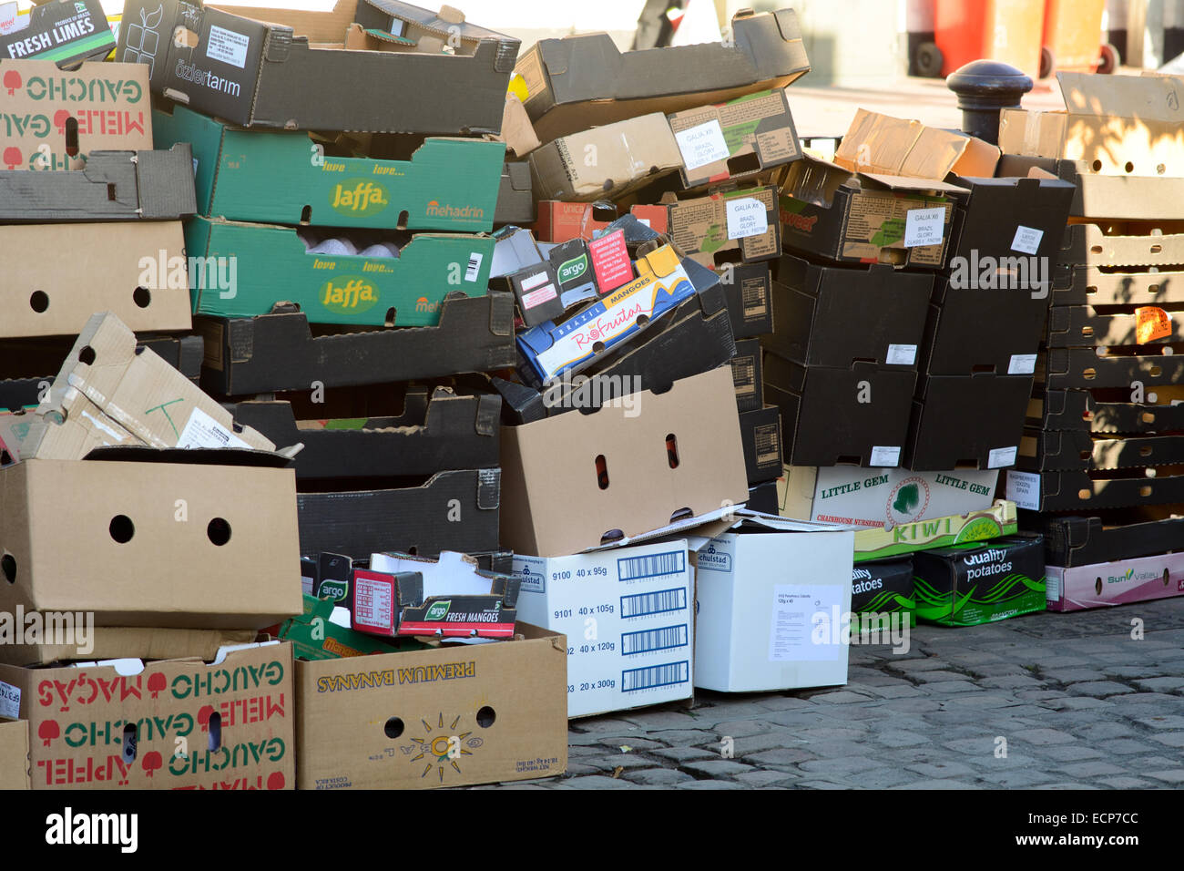 Cardboard fruit and vegetable boxes stacked at market stall Stock Photo ...