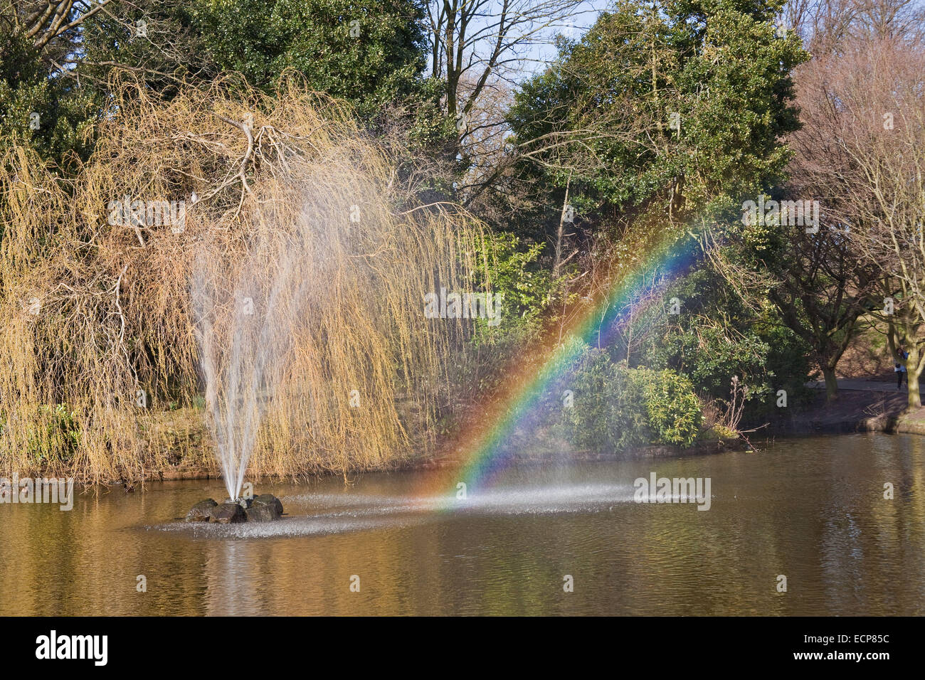 water feature in a park ,and a small but obvious rainbow Stock Photo ...