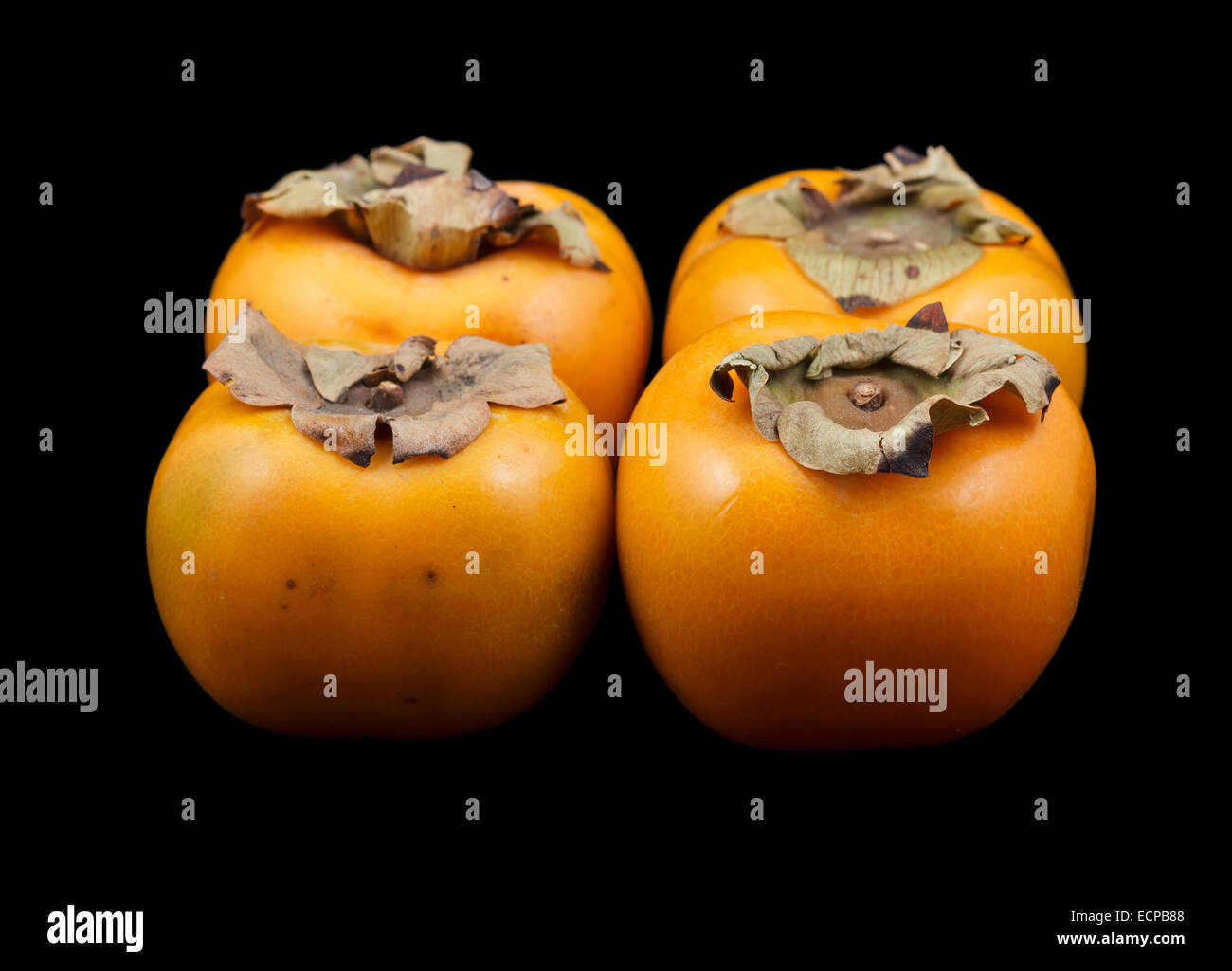 Four persimmon fruits Stock Photo - Alamy