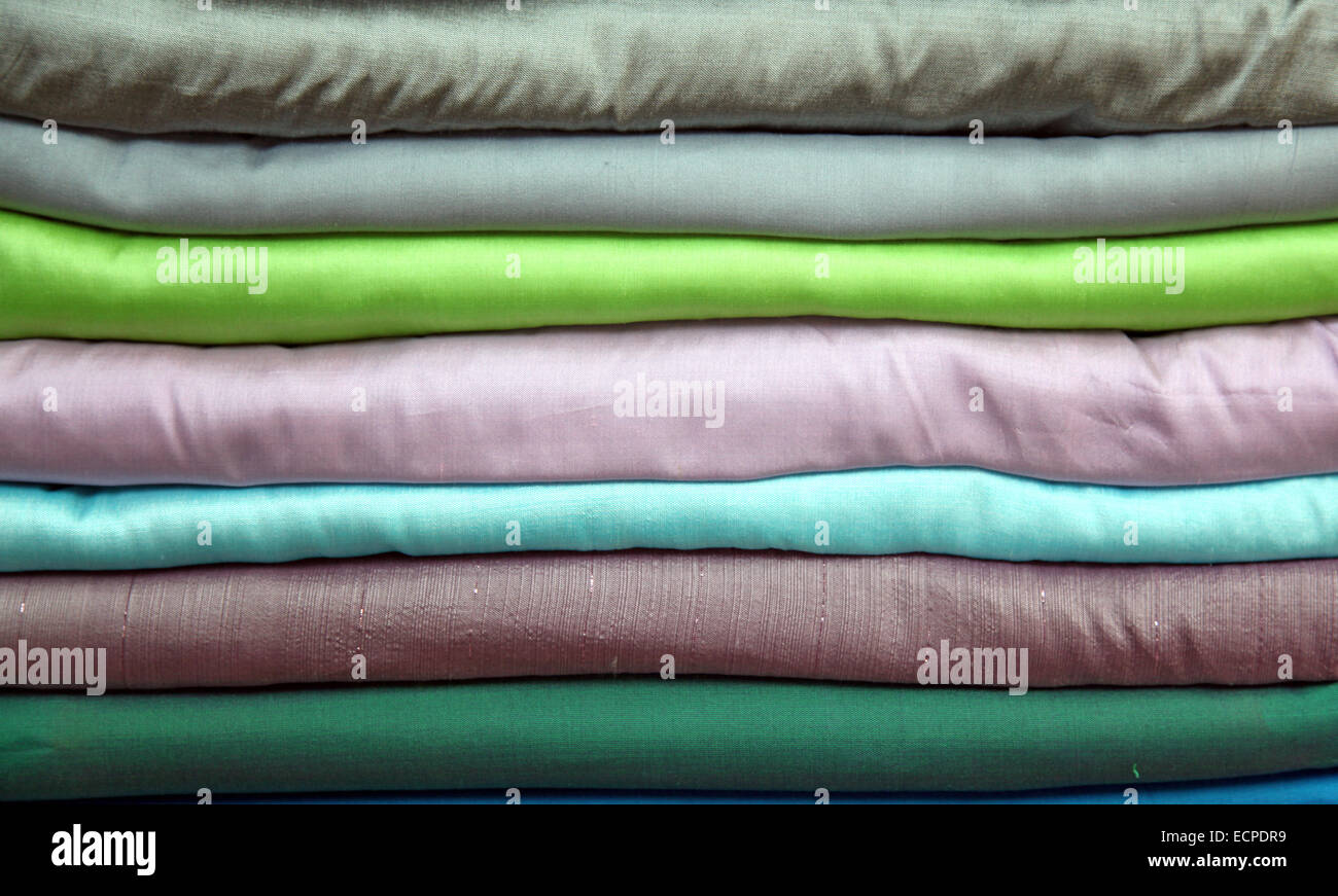 stack of colorful praewa silk fabric cloth using as background Stock ...