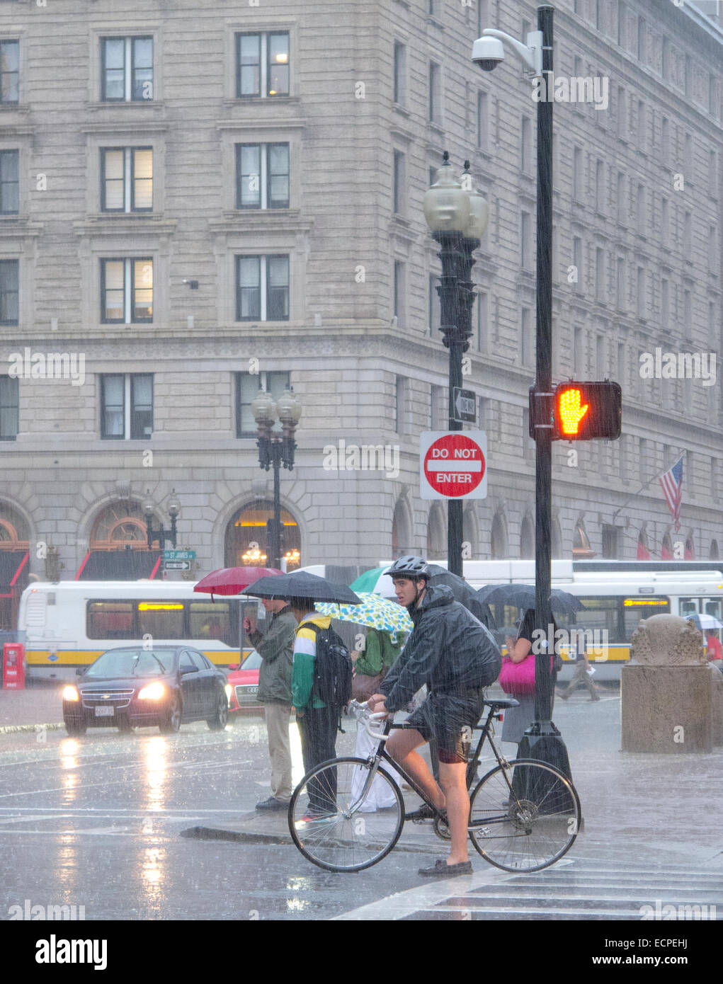A cyclist waits at a boston traffic light in the rain Stock Photo - Alamy