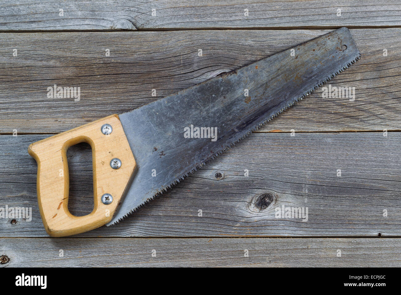 Used Hand saw on rustic wooden boards Stock Photo - Alamy