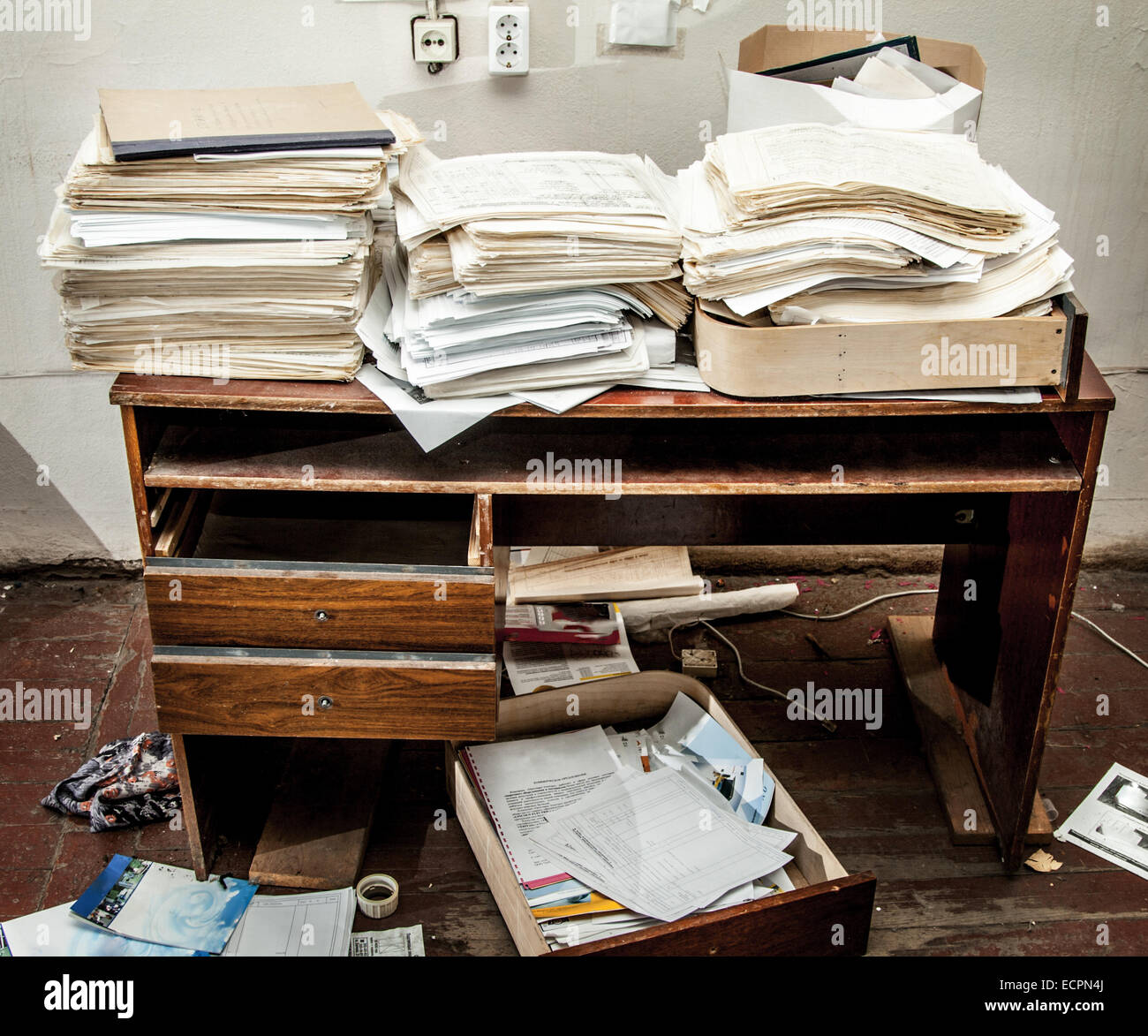 Messy workplace with stack of old paper Stock Photo - Alamy