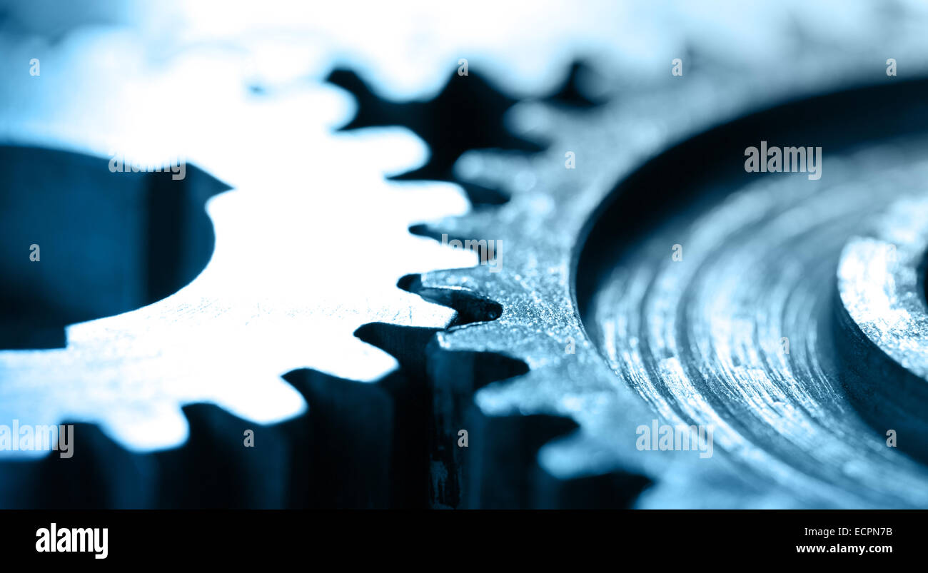 Three steel cogwheels in connection in closeup Stock Photo - Alamy