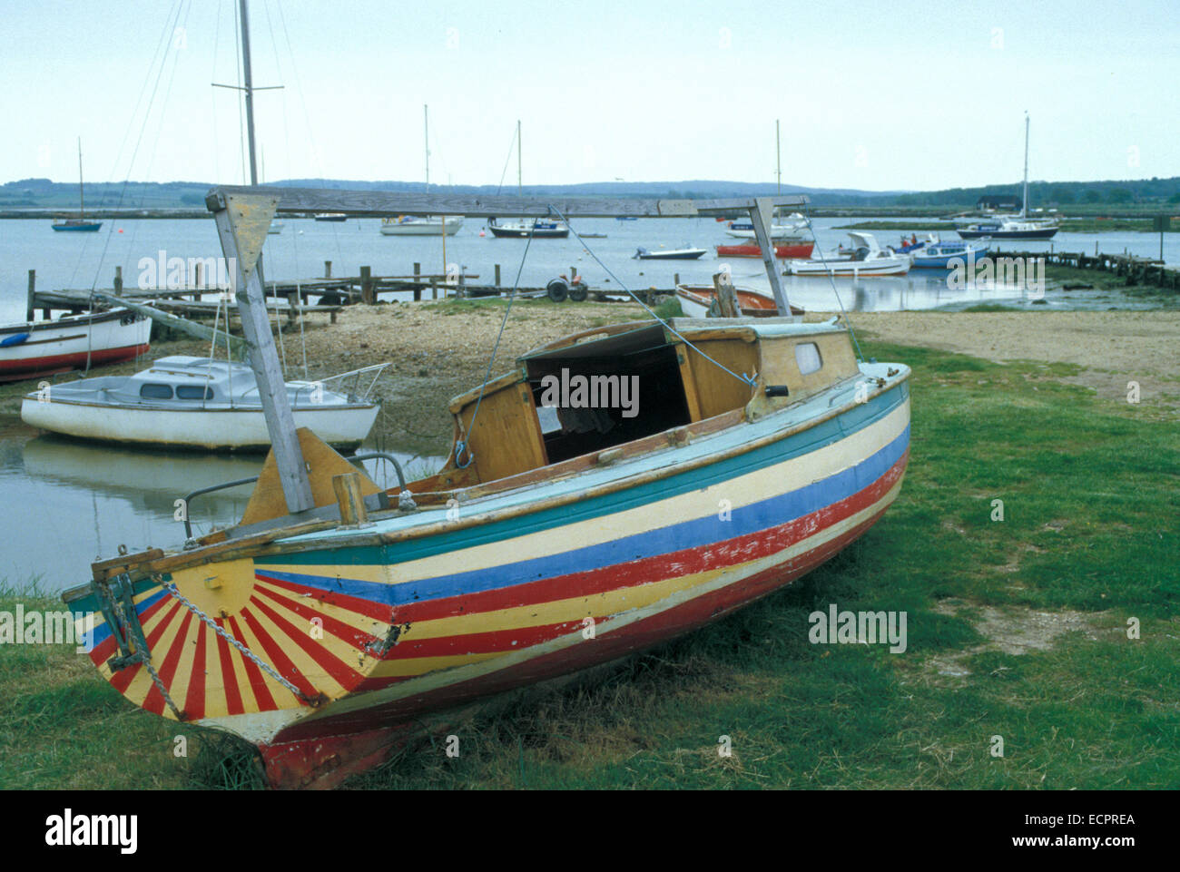 Multi Coloured Boat on the mud at Newtown River, Hamstead Quay, Isle of ...