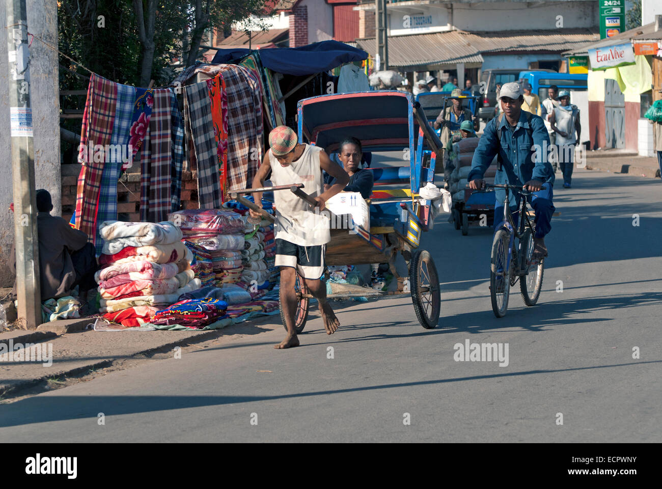 Pousse-pousse Driver and Passenger in Madagascar Stock Photo - Alamy
