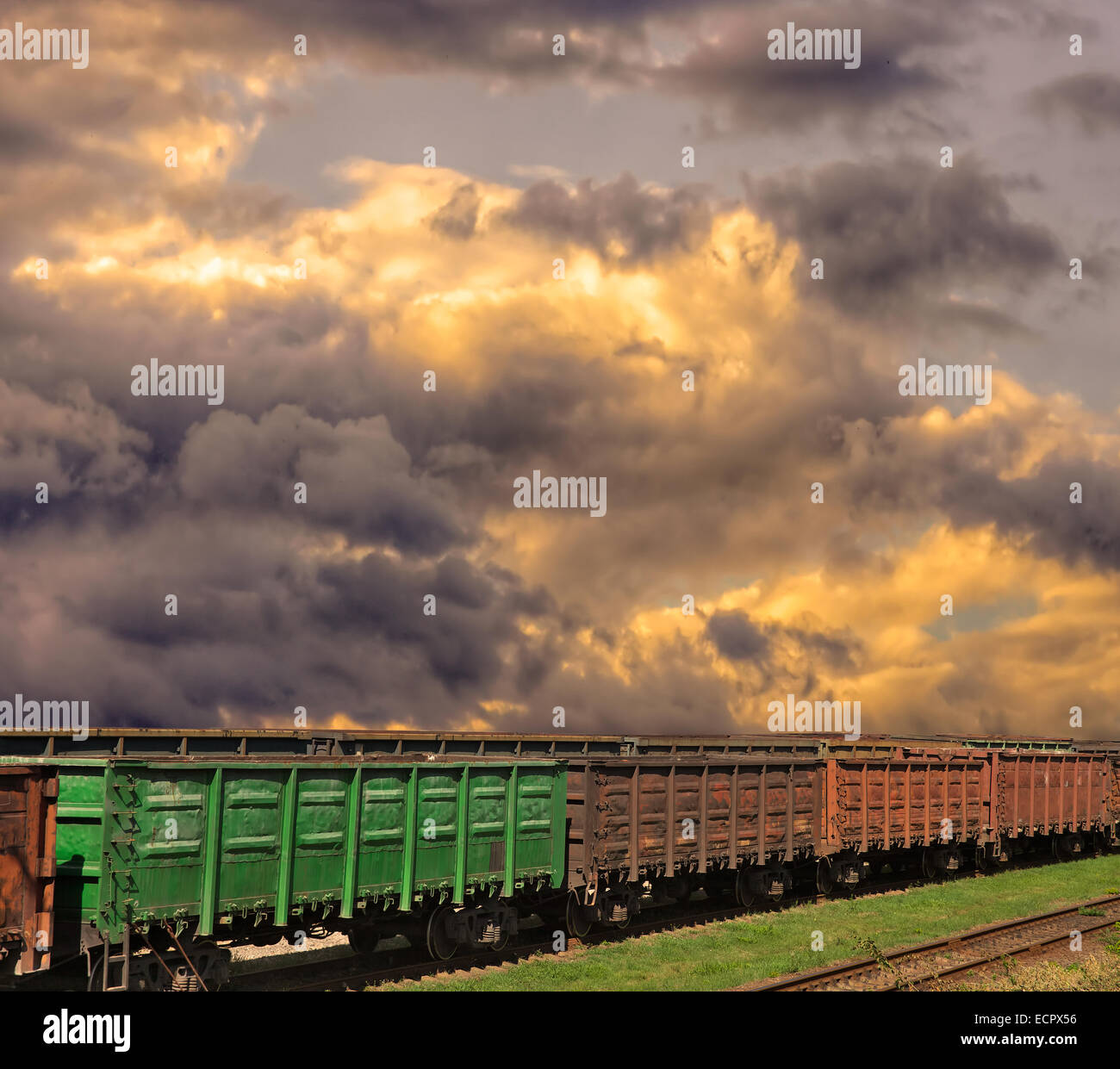 Cargo trains with sunset stormy clouds Stock Photo - Alamy
