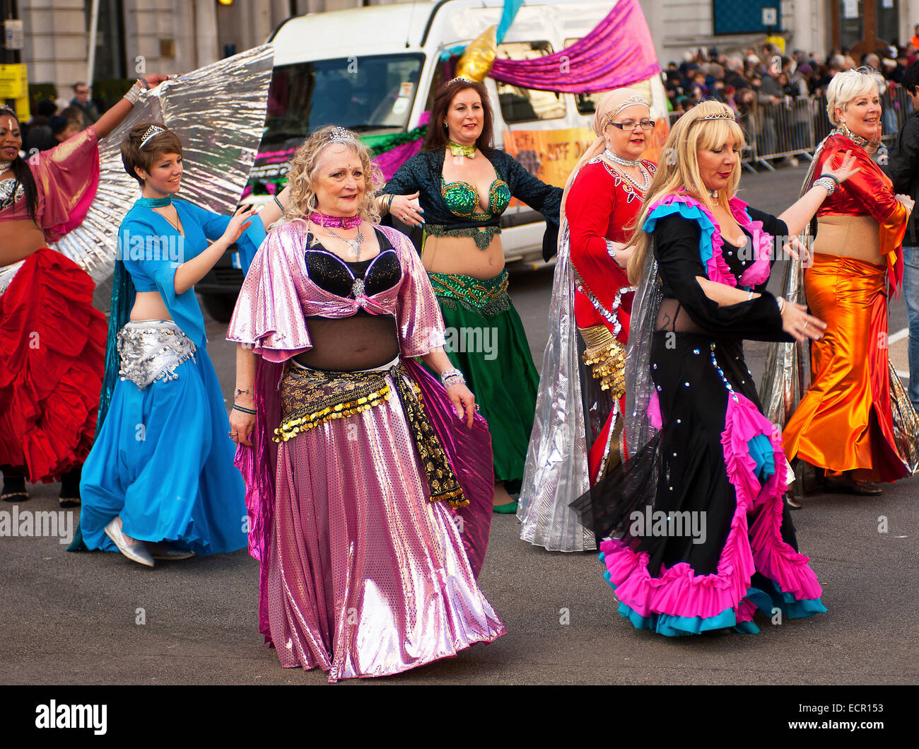 A group of ladies from a belly-dancing club dance through the streets ...