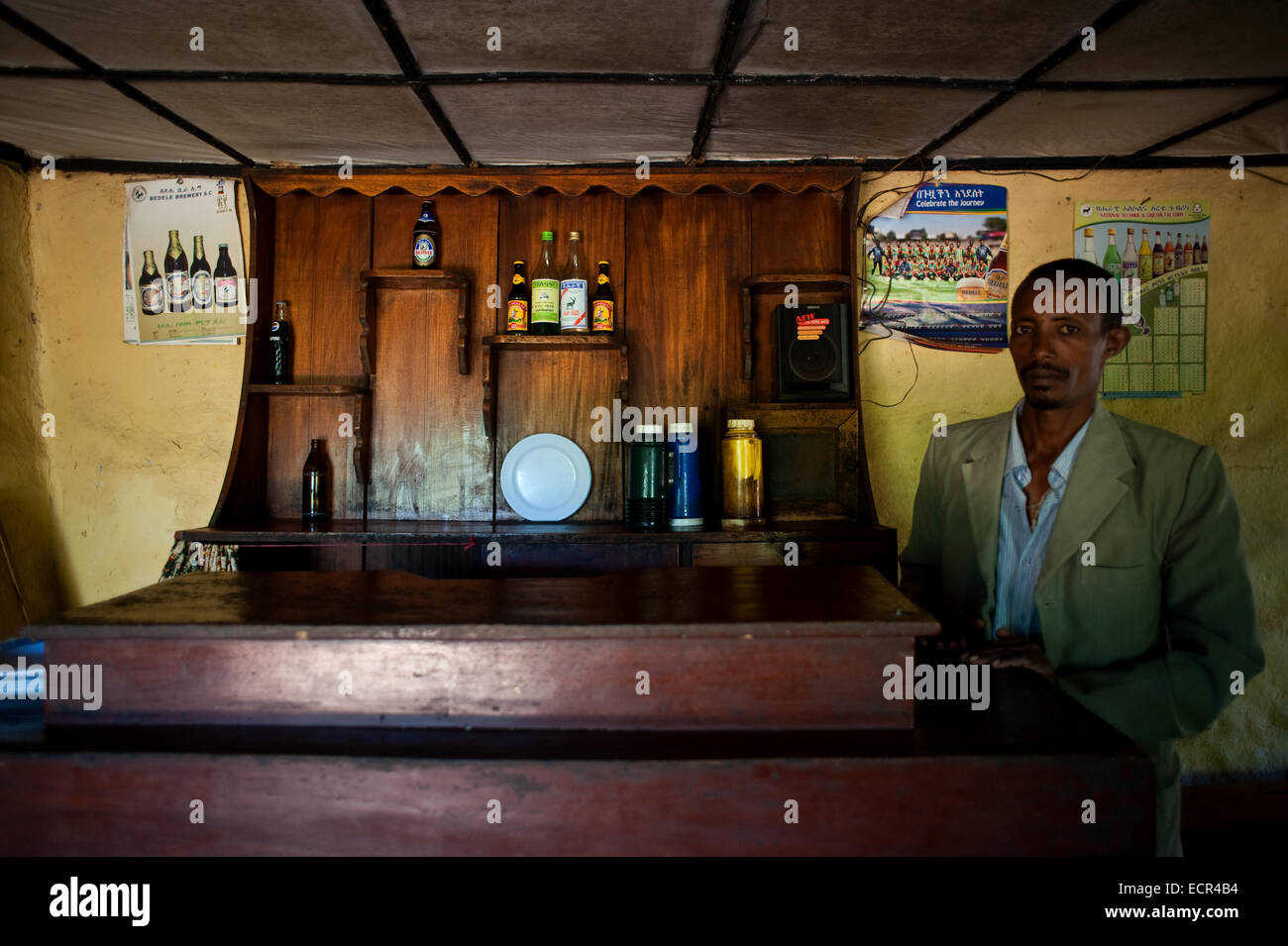 Bar owner inside his bar. He sells cafe, tea and local alcohols ...