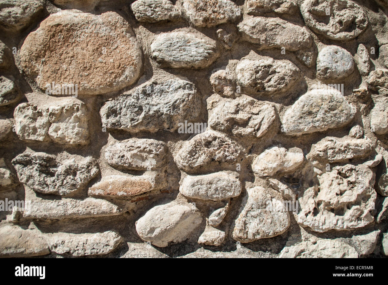 Ruin wall of bumpy and differents brown rocks Stock Photo - Alamy