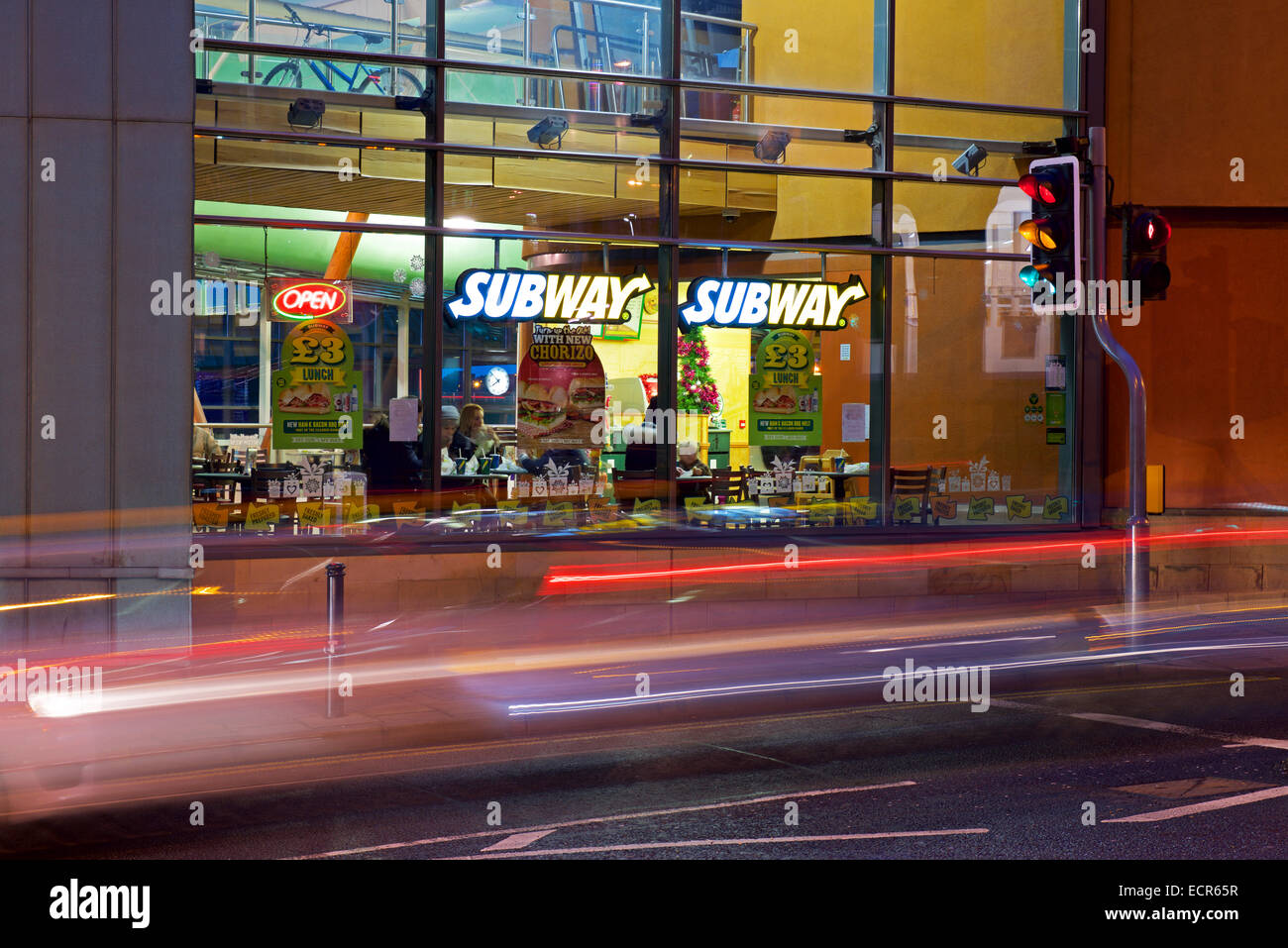 Subway sandwich shop at dusk, with blurred car-lights Stock Photo - Alamy
