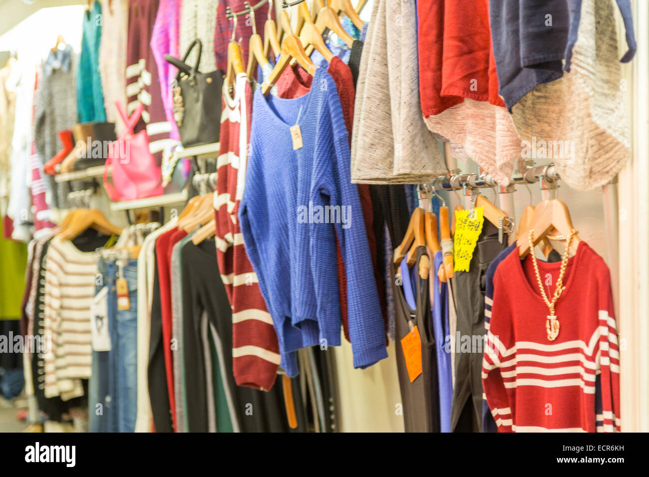 Clothing on hangers at a store in a night market Stock Photo - Alamy