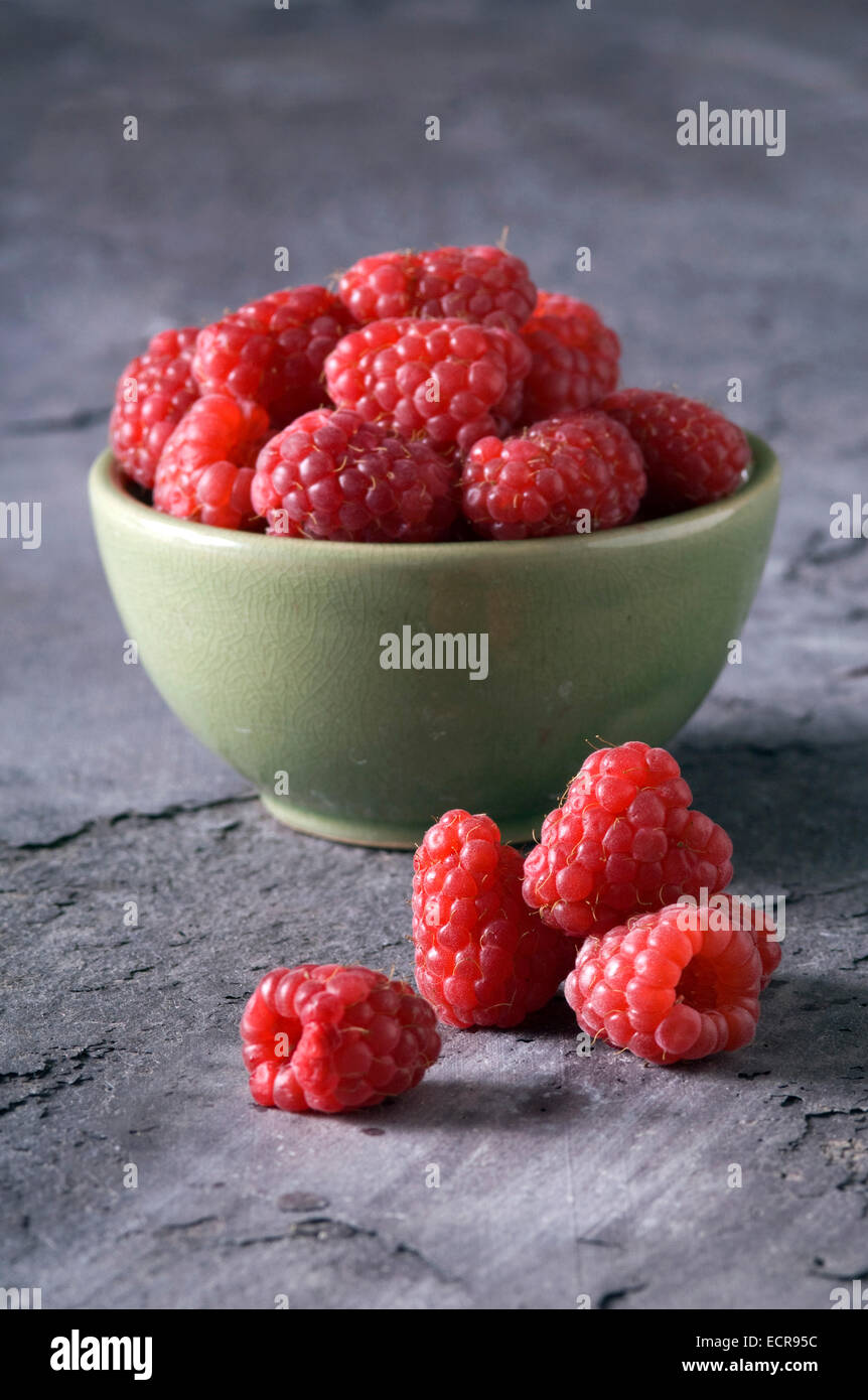 Raspberries in a green bowl Stock Photo - Alamy