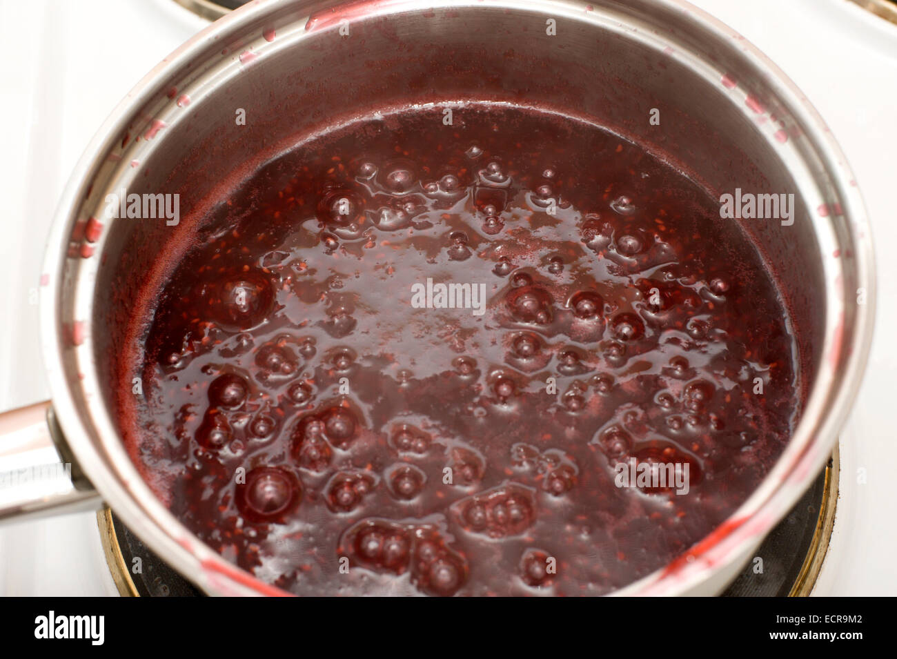 A pan of boiling fruit on a stove in readiness for making some homemade ...