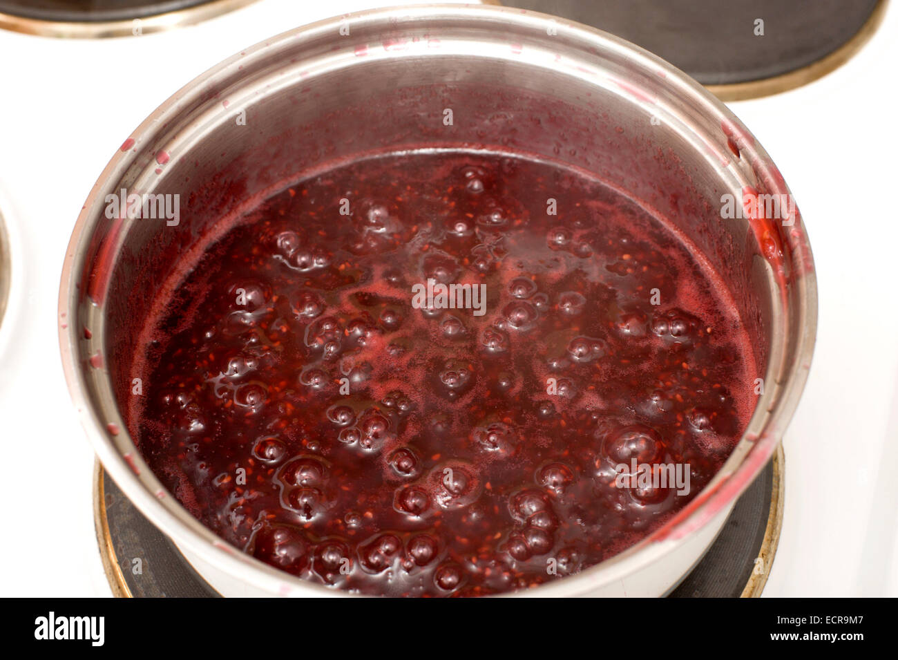 A pan of boiling fruit on a stove in readiness for making some homemade ...