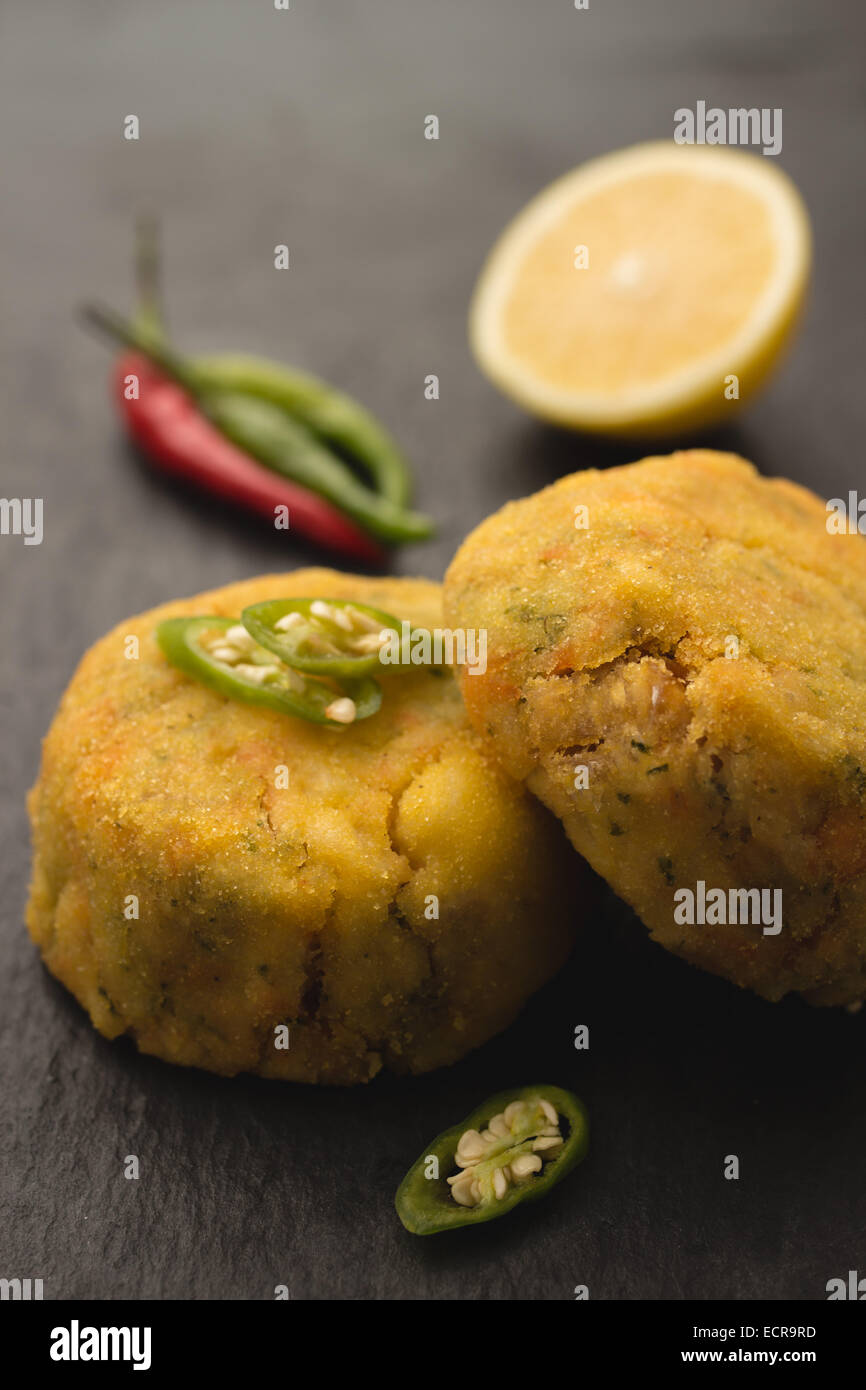 Salmon fishcakes with fresh chilli, chive parsley and lemon Stock Photo ...