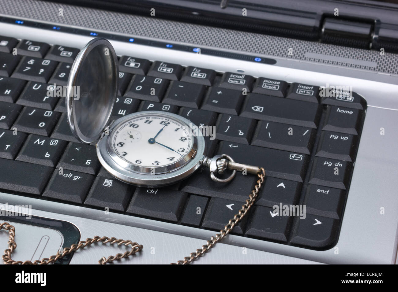 pocket watch on a laptop keyboard Stock Photo - Alamy