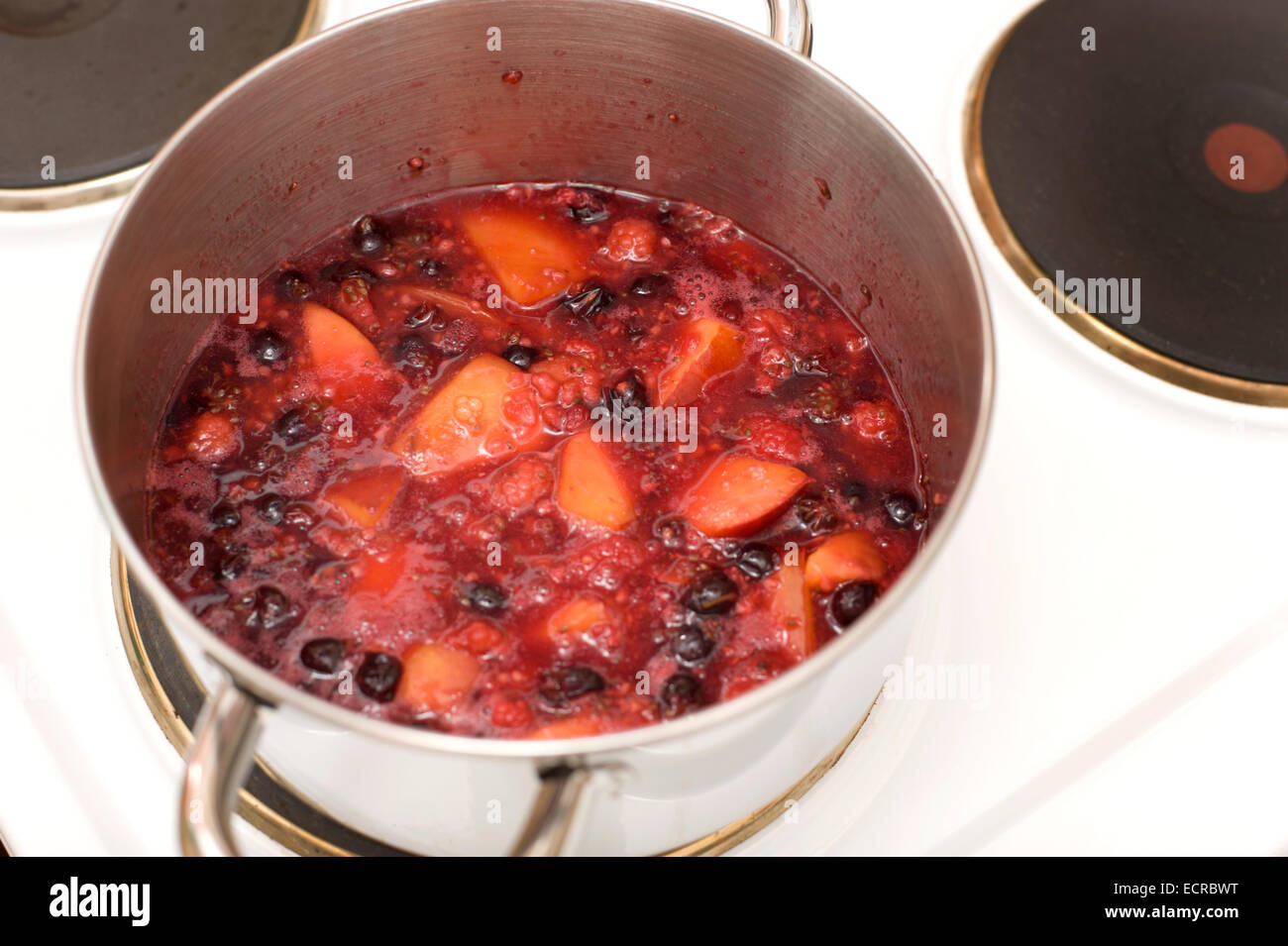 A pot of boiling fruit being reduced in readiness for jam making plus ...