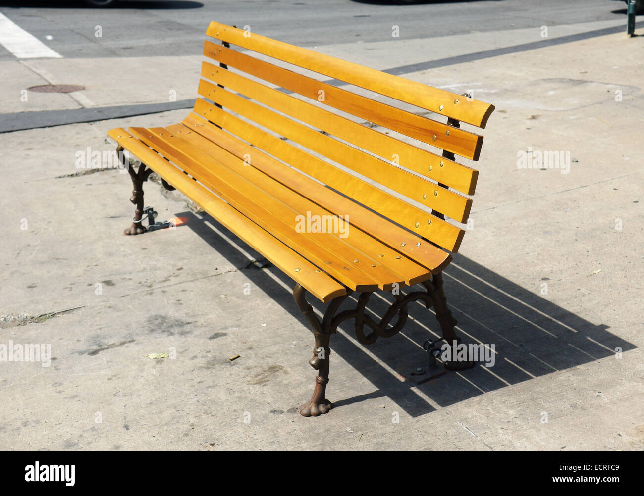 Wood bench on the sidewalk in the city Stock Photo - Alamy