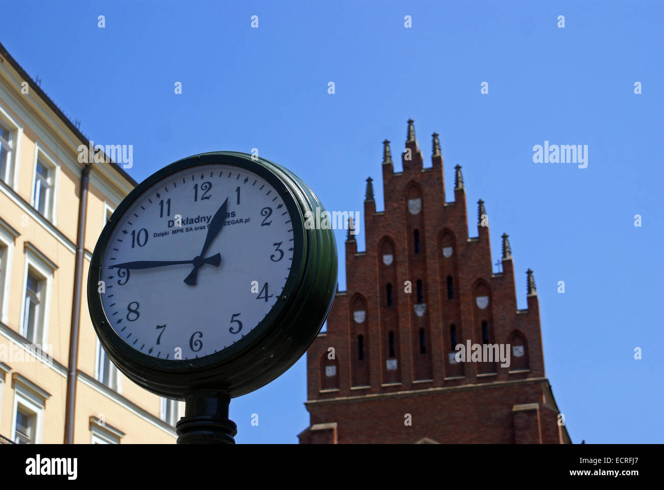 A clock showing a time of 12.46 PM in Krakow, Poland Stock Photo - Alamy