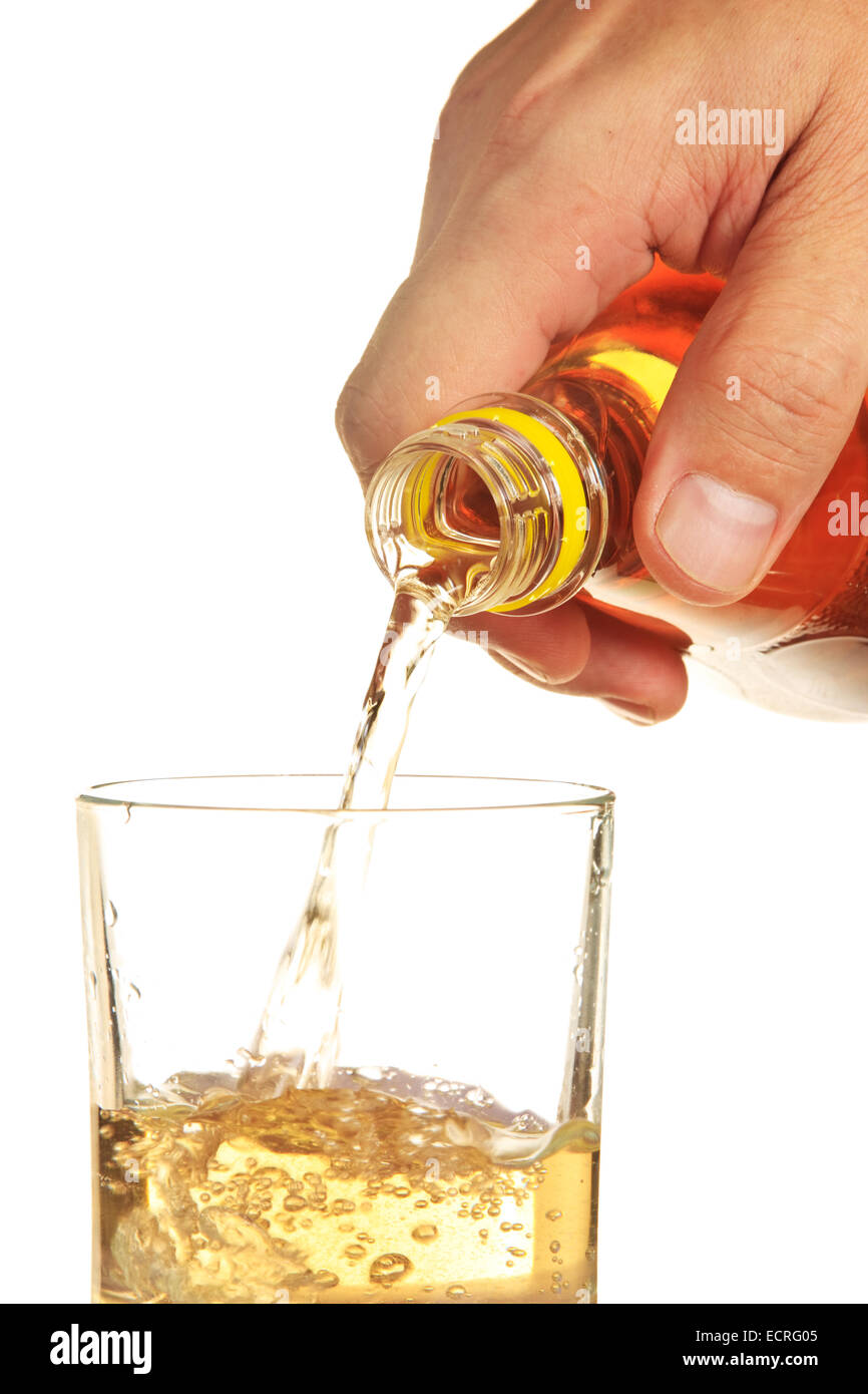 man's hand pours a drink into a glass isolated on a white background ...